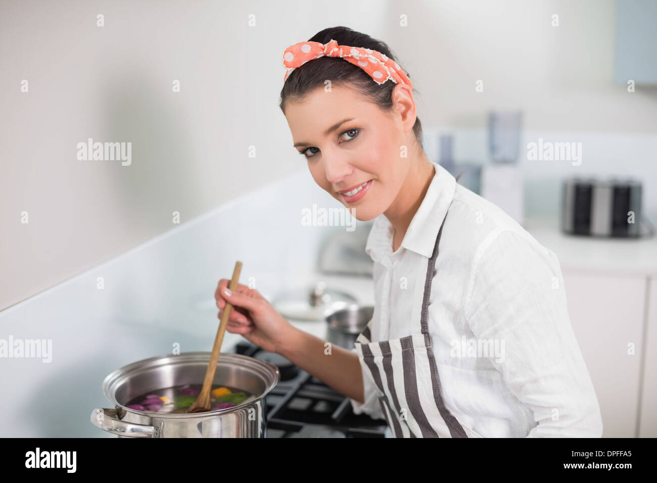 Happy gorgeous cook posing Stock Photo - Alamy