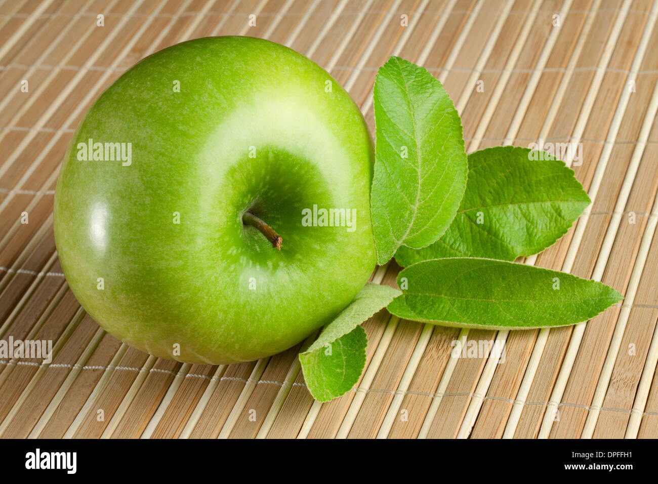 Green apple with leaves on wooden background Stock Photo - Alamy