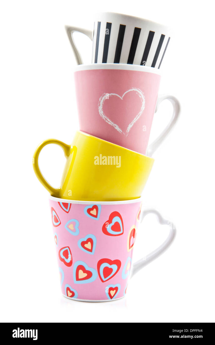 Four colorful cups on a stack isolated over white Stock Photo - Alamy