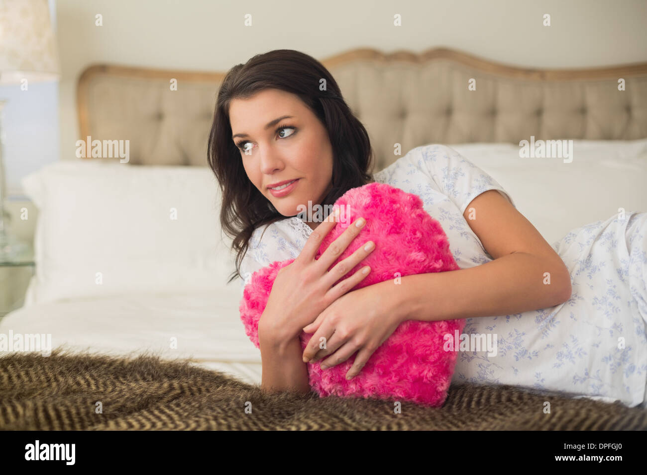 Happy woman hugging heart pillow hi-res stock photography and images ...