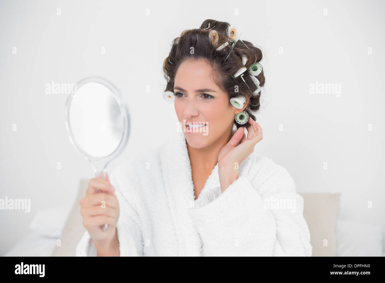 Pretty natural brunette looking at mirror Stock Photo - Alamy