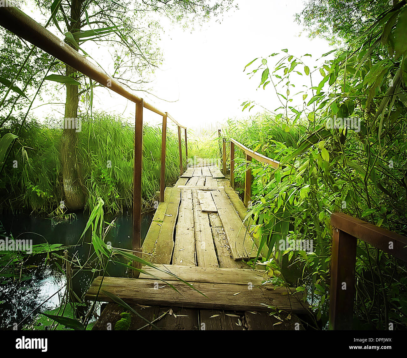 Old wooden bridge over a small river Stock Photo - Alamy