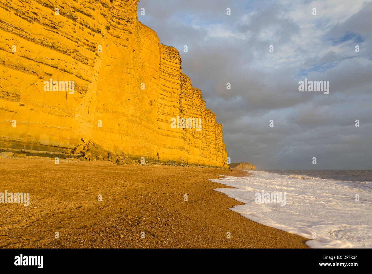 The late afternoon winter sun lights up the red sandstone cliffs at ...