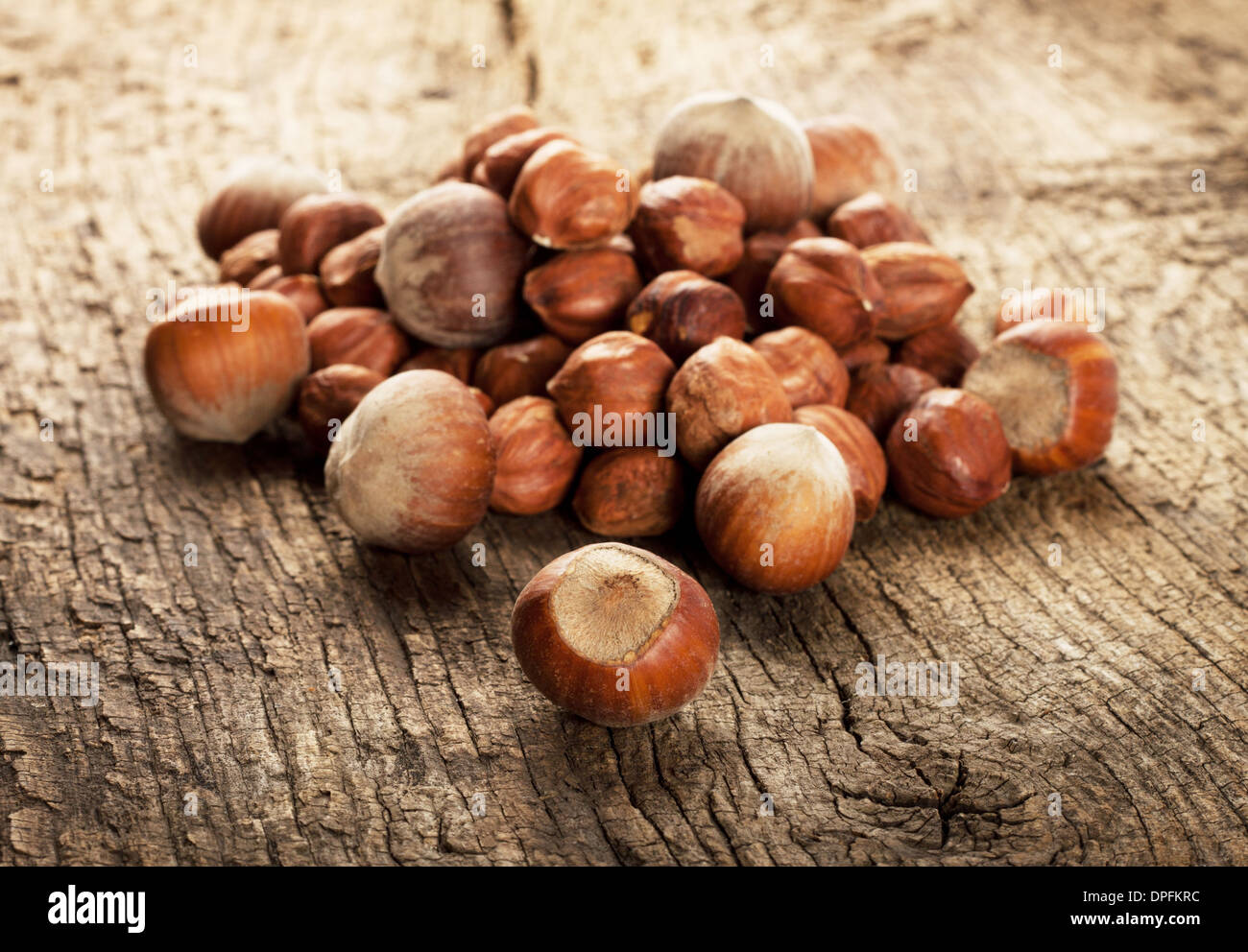 Pile of ripe hazelnuts on wooden background Stock Photo - Alamy