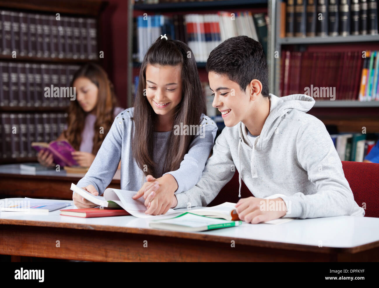 Teenage Couple Studying Together In Library Stock Photo - Alamy