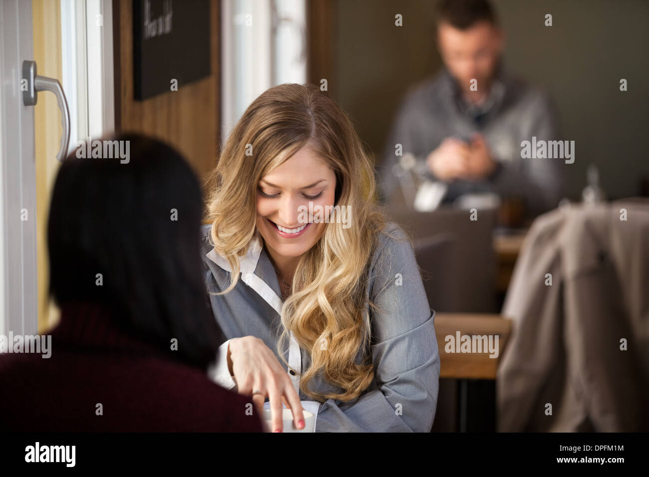 Female Friends Having Coffee At Cafe Stock Photo - Alamy