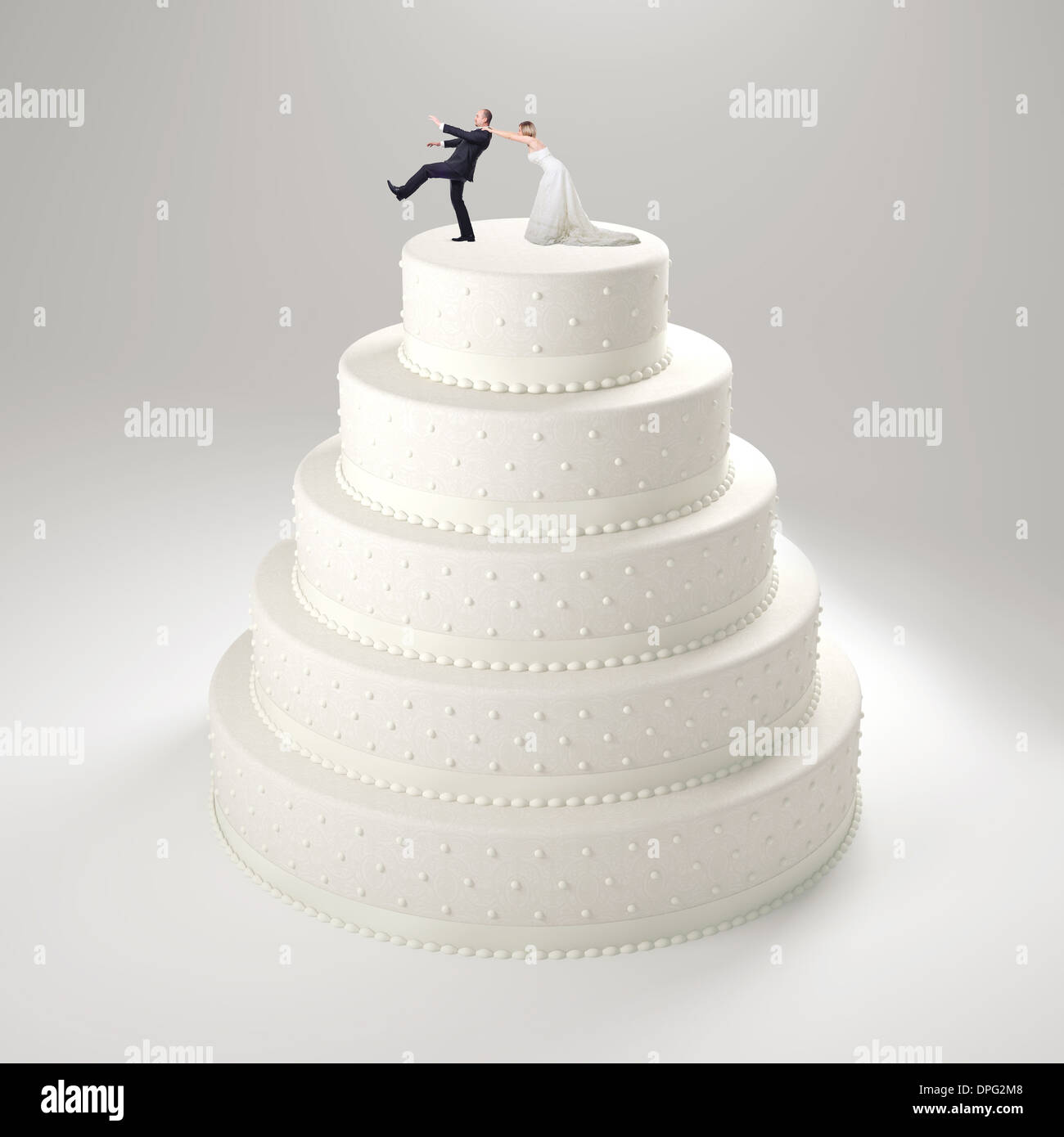 classic wedding cake with groom and bride Stock Photo - Alamy