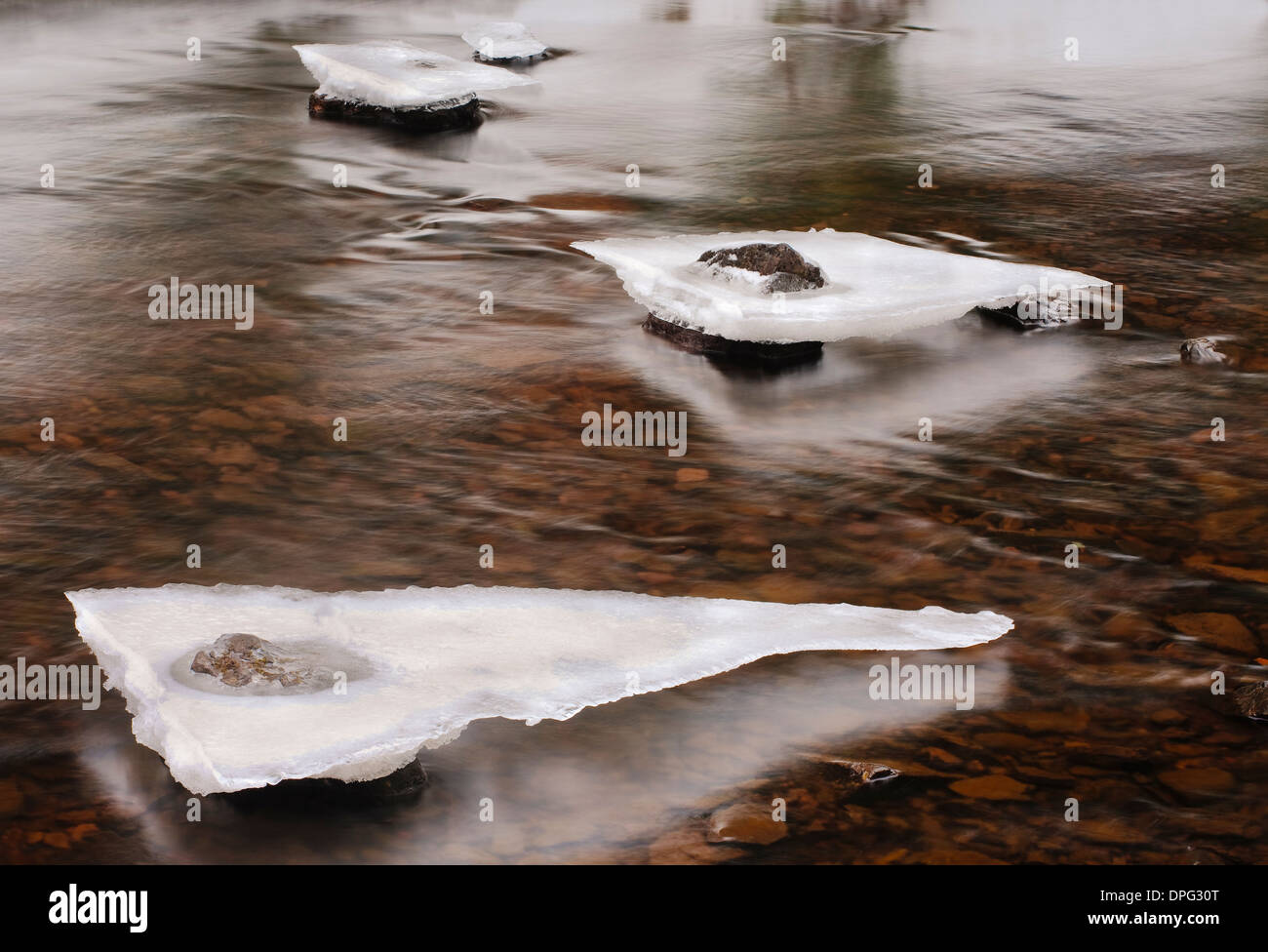 Melting ice in stream Stock Photo - Alamy