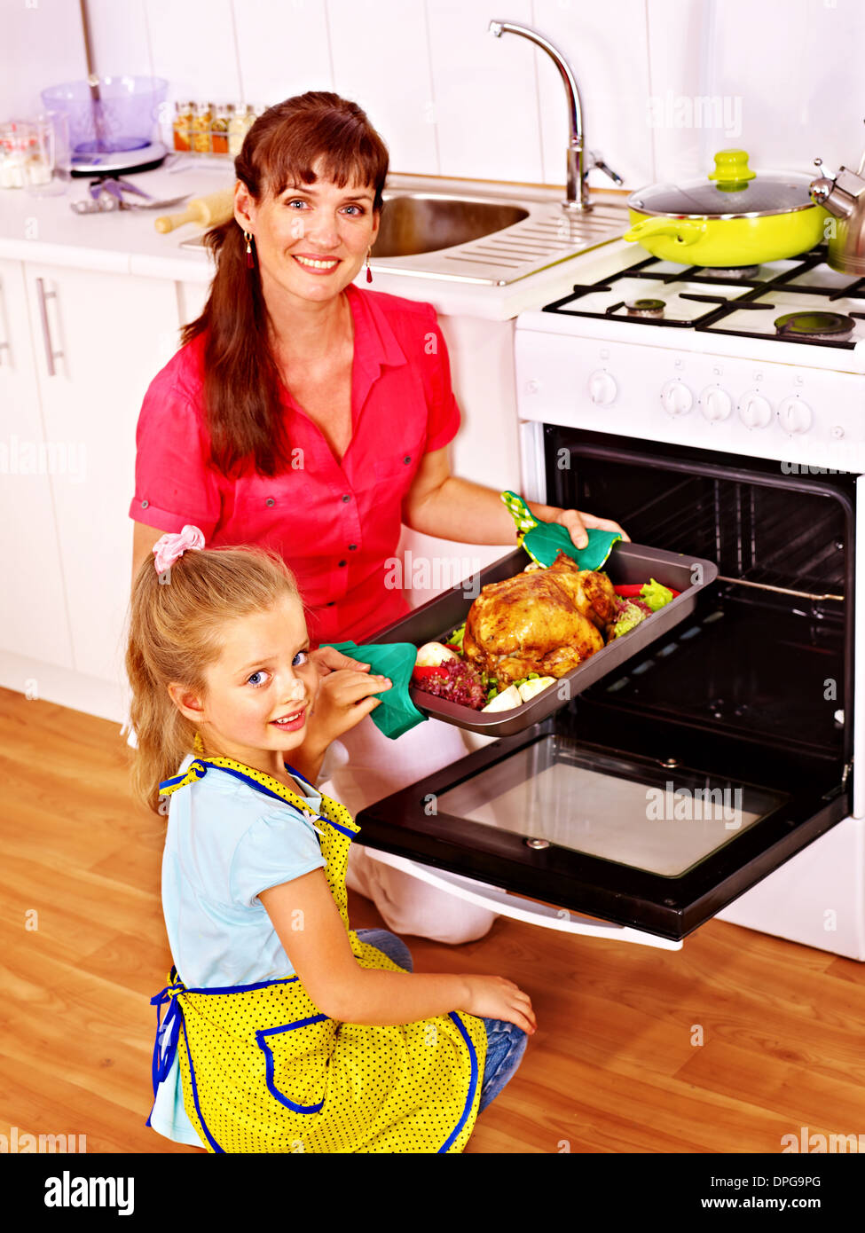 Woman cooking chicken at kitchen Stock Photo - Alamy