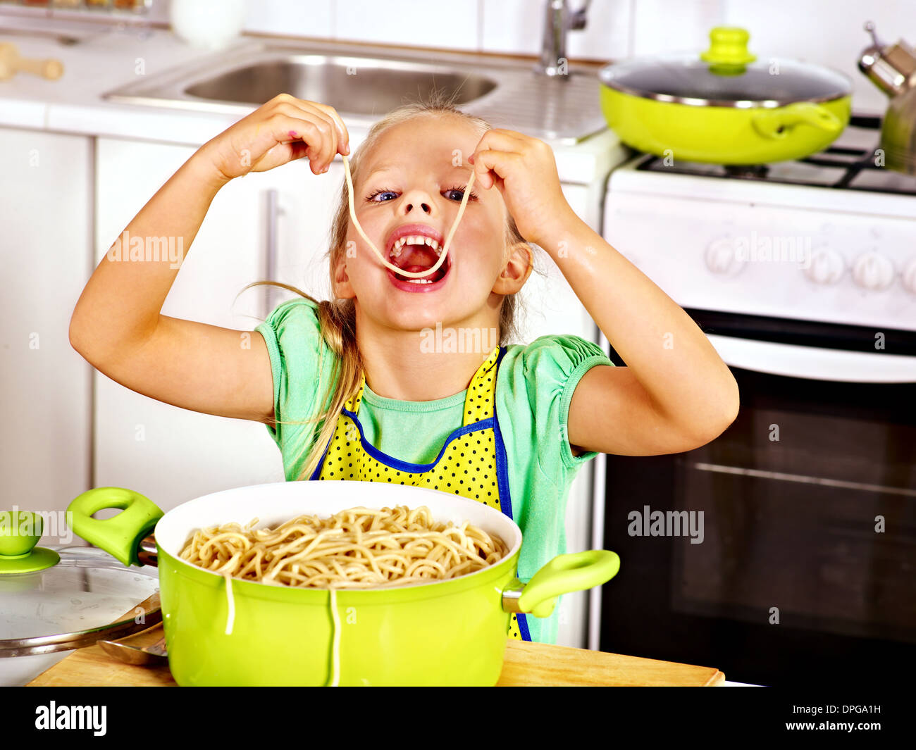 Children eating spaghetti at kitchen Stock Photo - Alamy