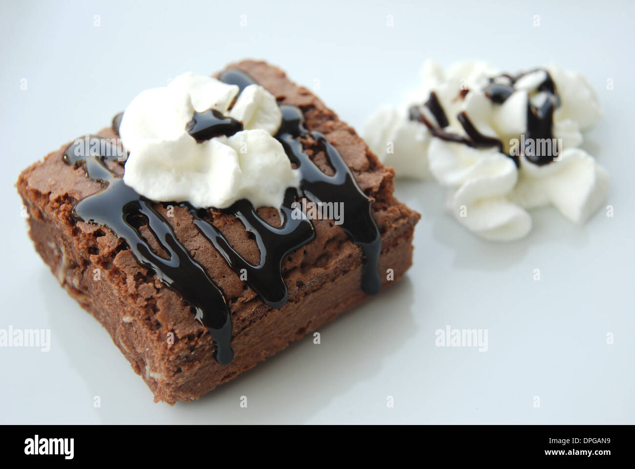 chocolate brownie cake with chocolate syrup topping Stock Photo - Alamy