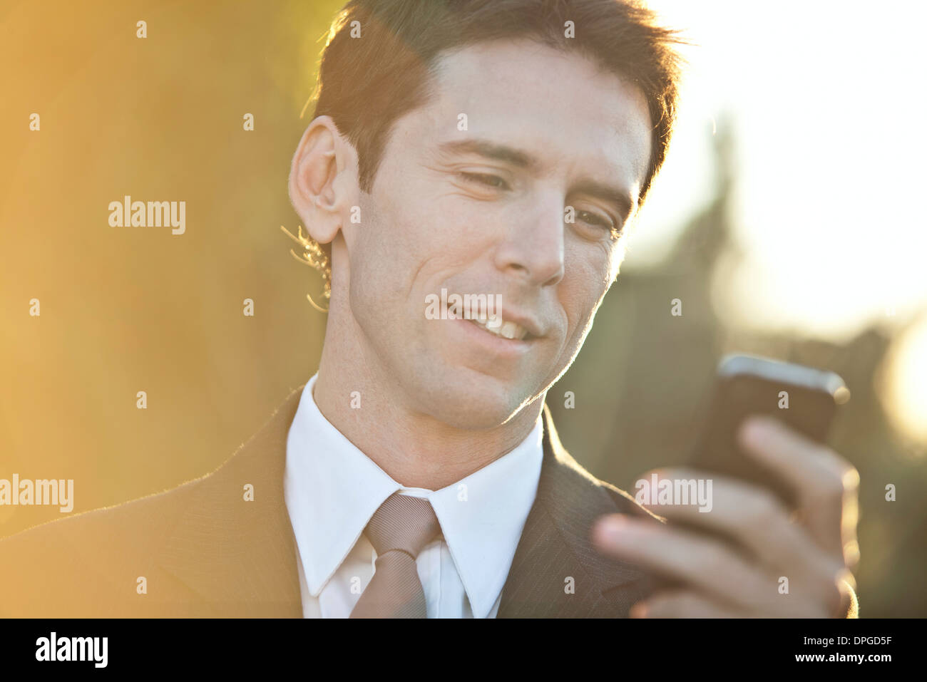 Business man uses phone checking hi-res stock photography and images ...