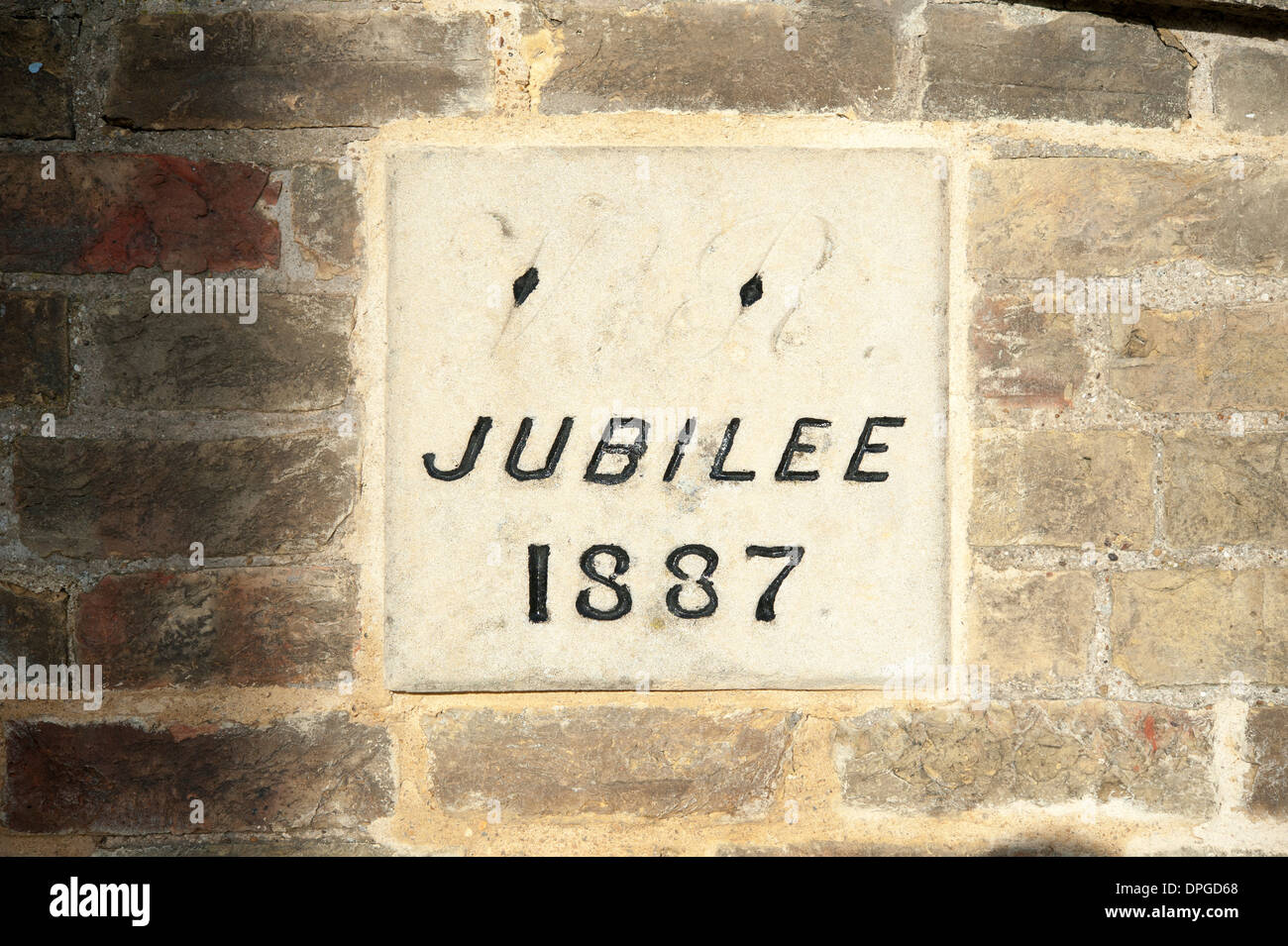 A masonry plaques in a wall in Willingham Cambridgeshire to commemorate ...