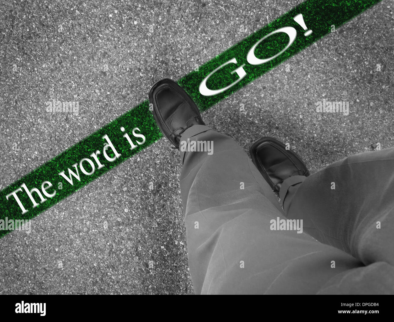 Man walking across a green line with words go Stock Photo - Alamy