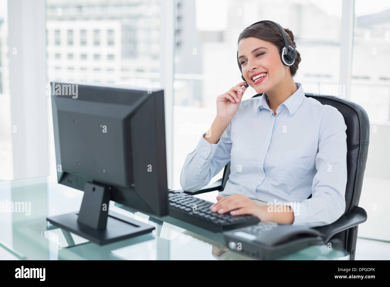Joyful classy brown haired operator answering a call Stock Photo - Alamy