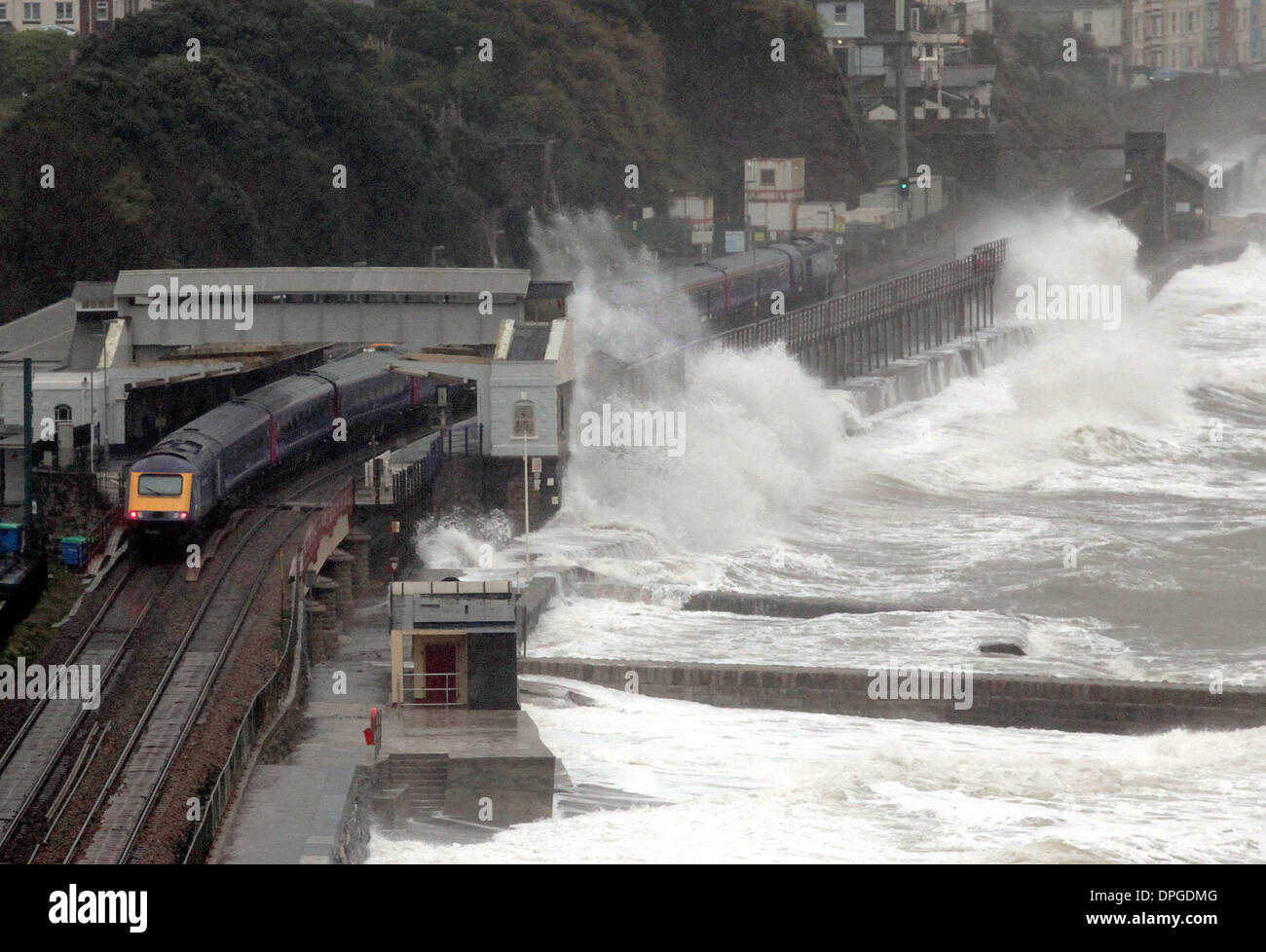 A train is battered by waves as it passes through the Dawlish train ...