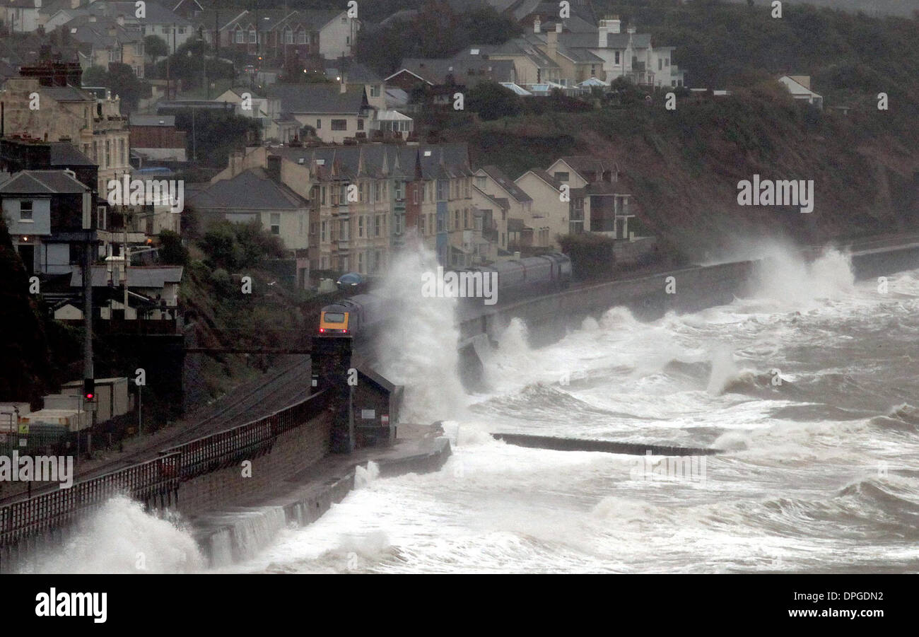 A train is battered by waves as it passes through the Dawlish train ...