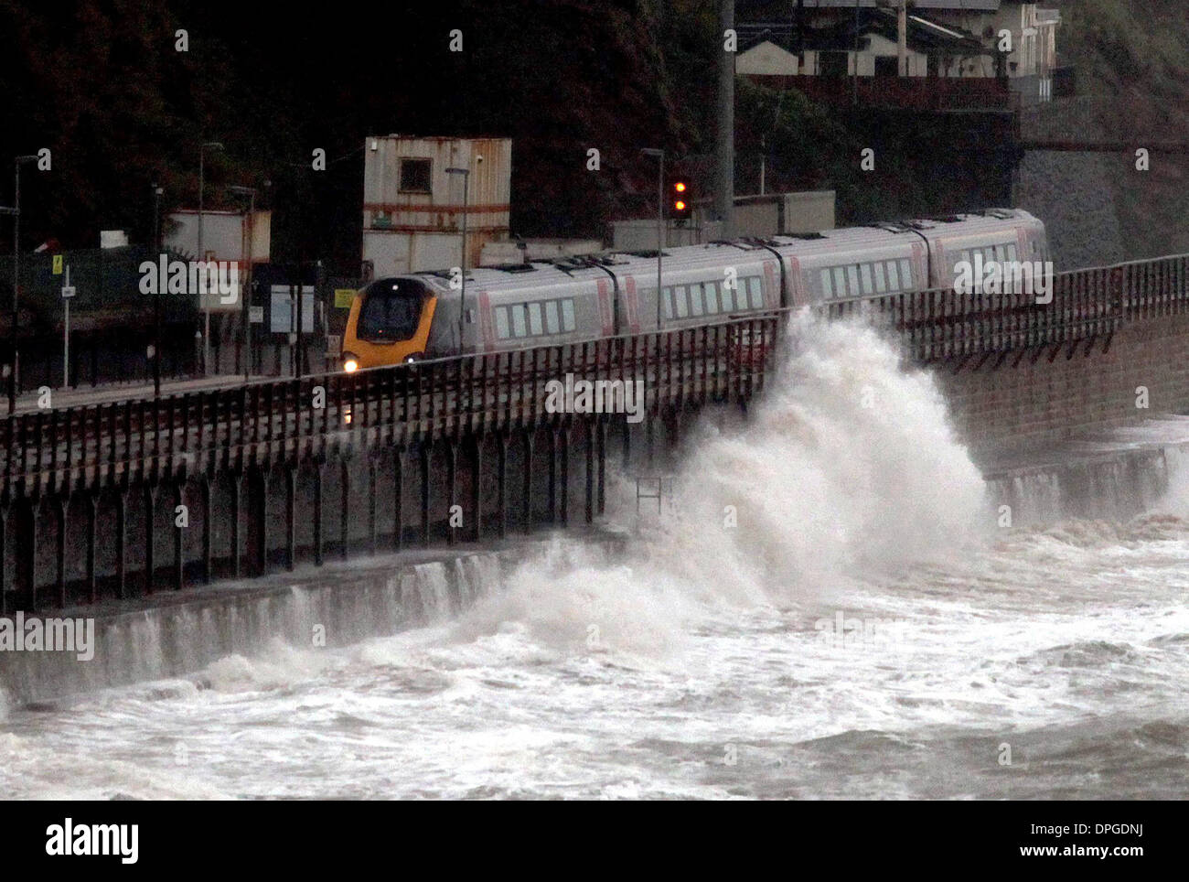 A train is battered by waves as it passes through the Dawlish train ...