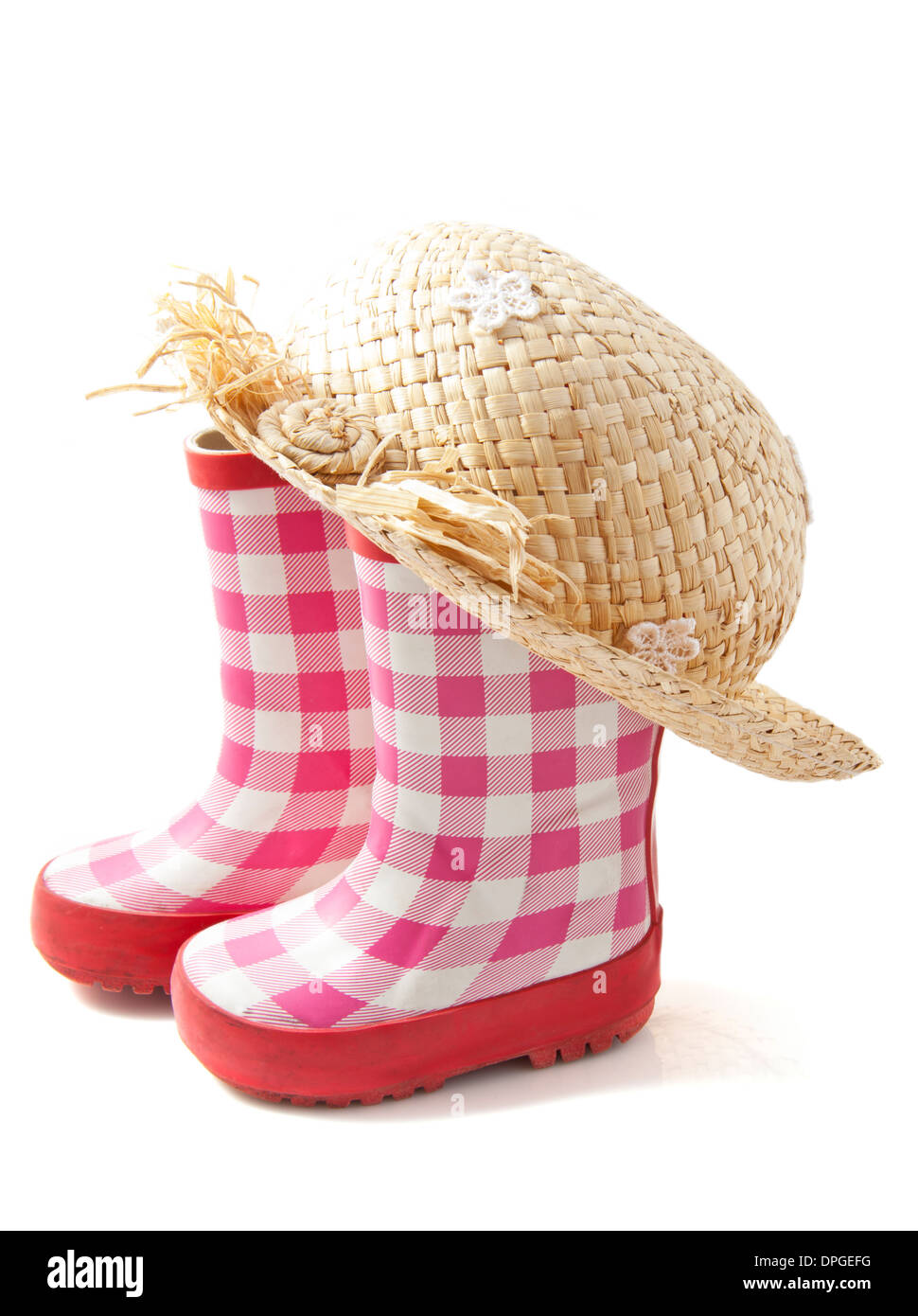 Rubber boots with straw head isolated over wiite Stock Photo - Alamy