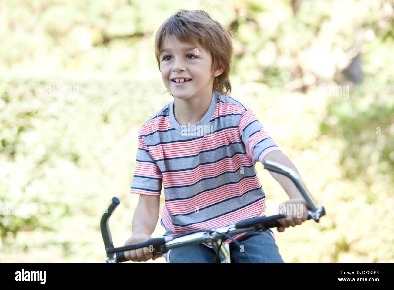Boy riding bicycle Stock Photo - Alamy