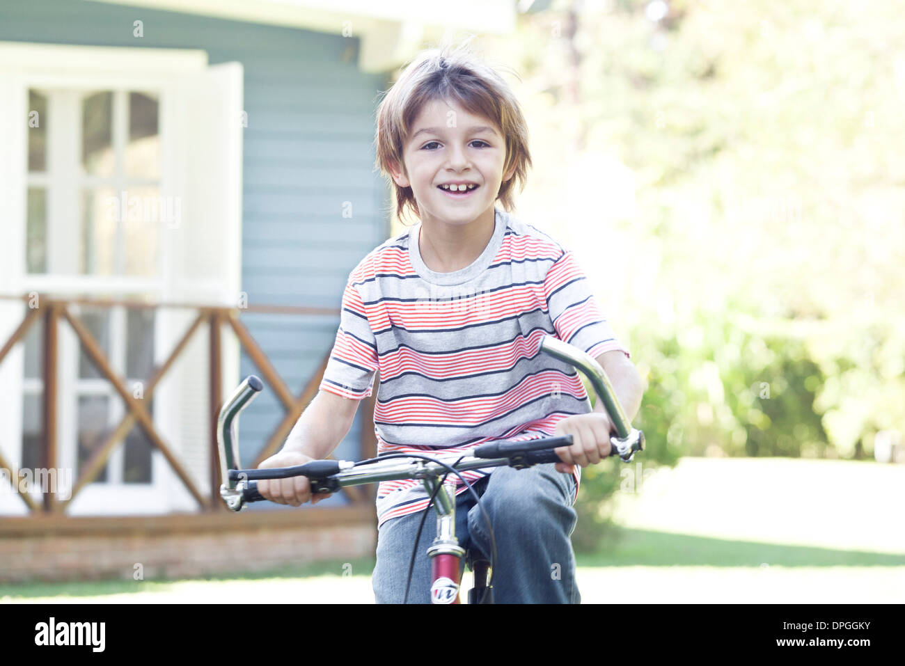 Boy riding bicycle Stock Photo - Alamy