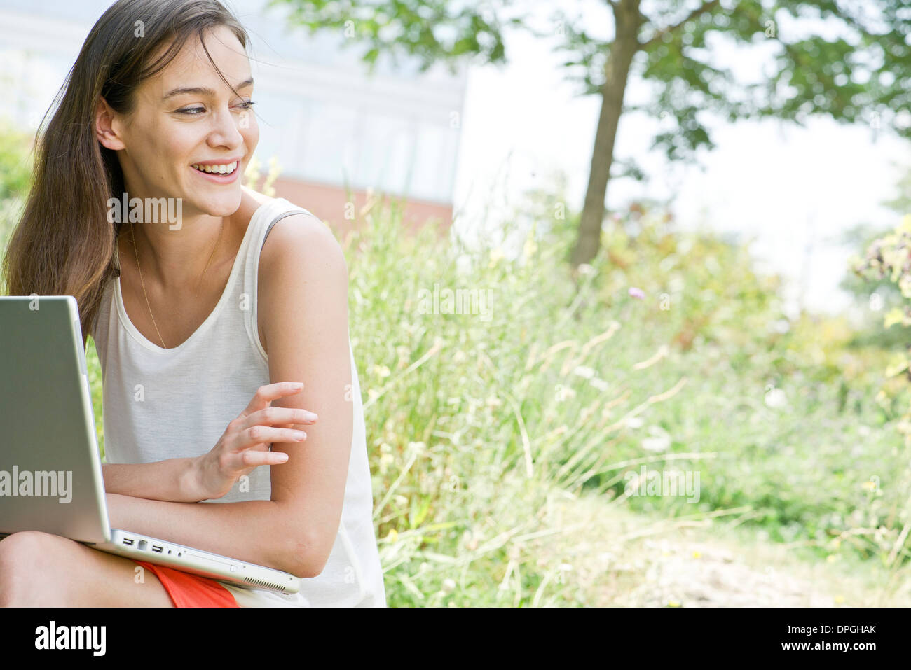 Woman using laptop computer outdoors Stock Photo - Alamy