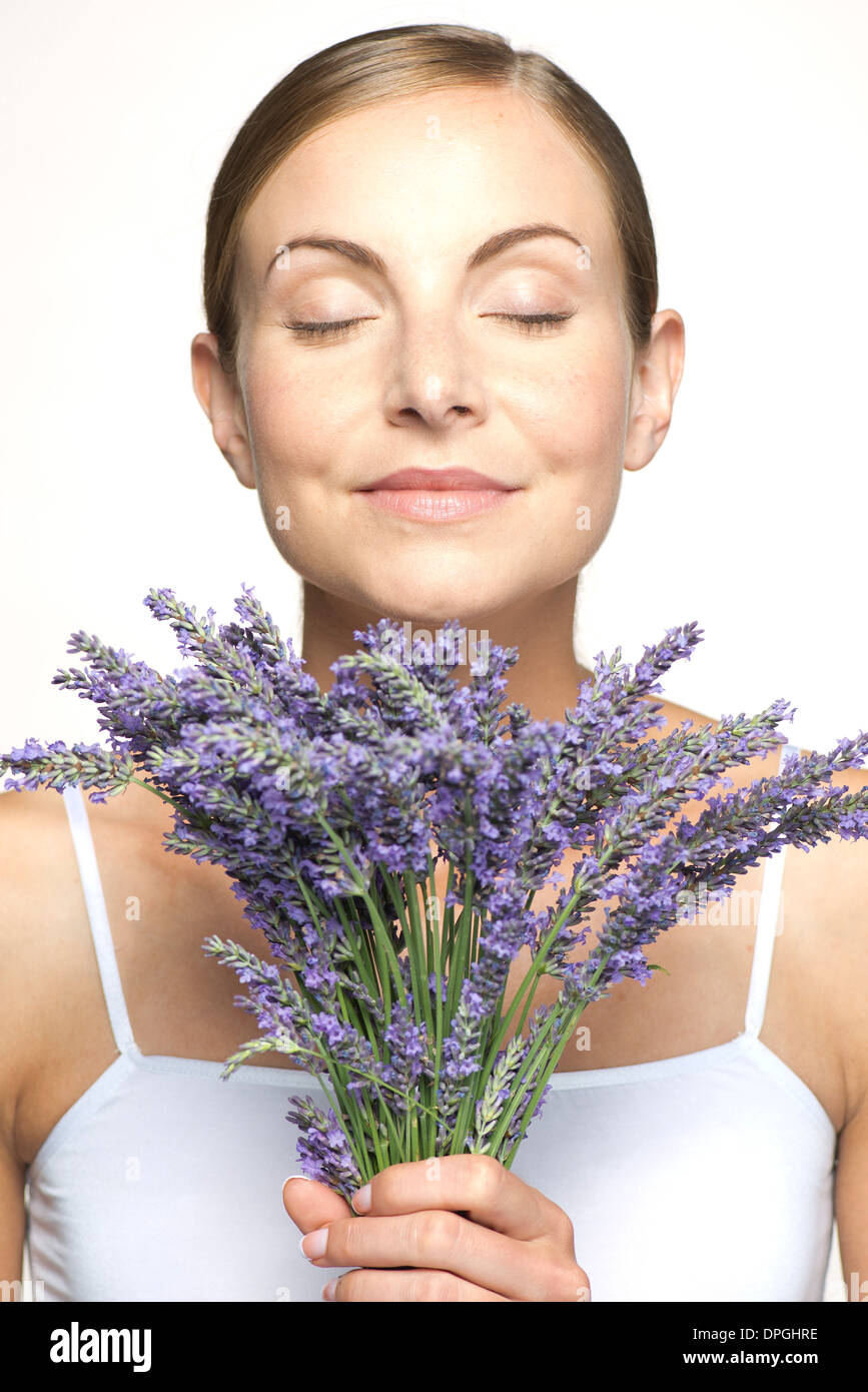 Woman smelling bouquet of fresh lavender with eyes closed Stock Photo ...