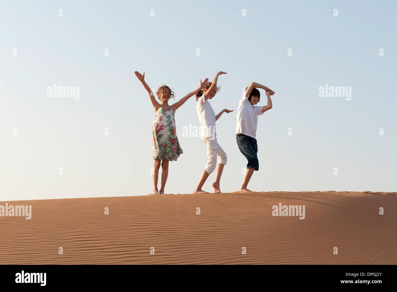 Children walking in desert, making gestures with arms Stock Photo - Alamy