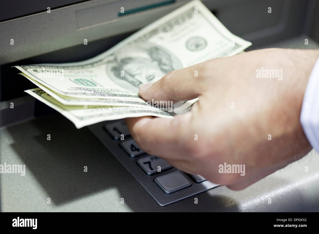 Hand withdrawing banknotes from atm hi-res stock photography and images ...