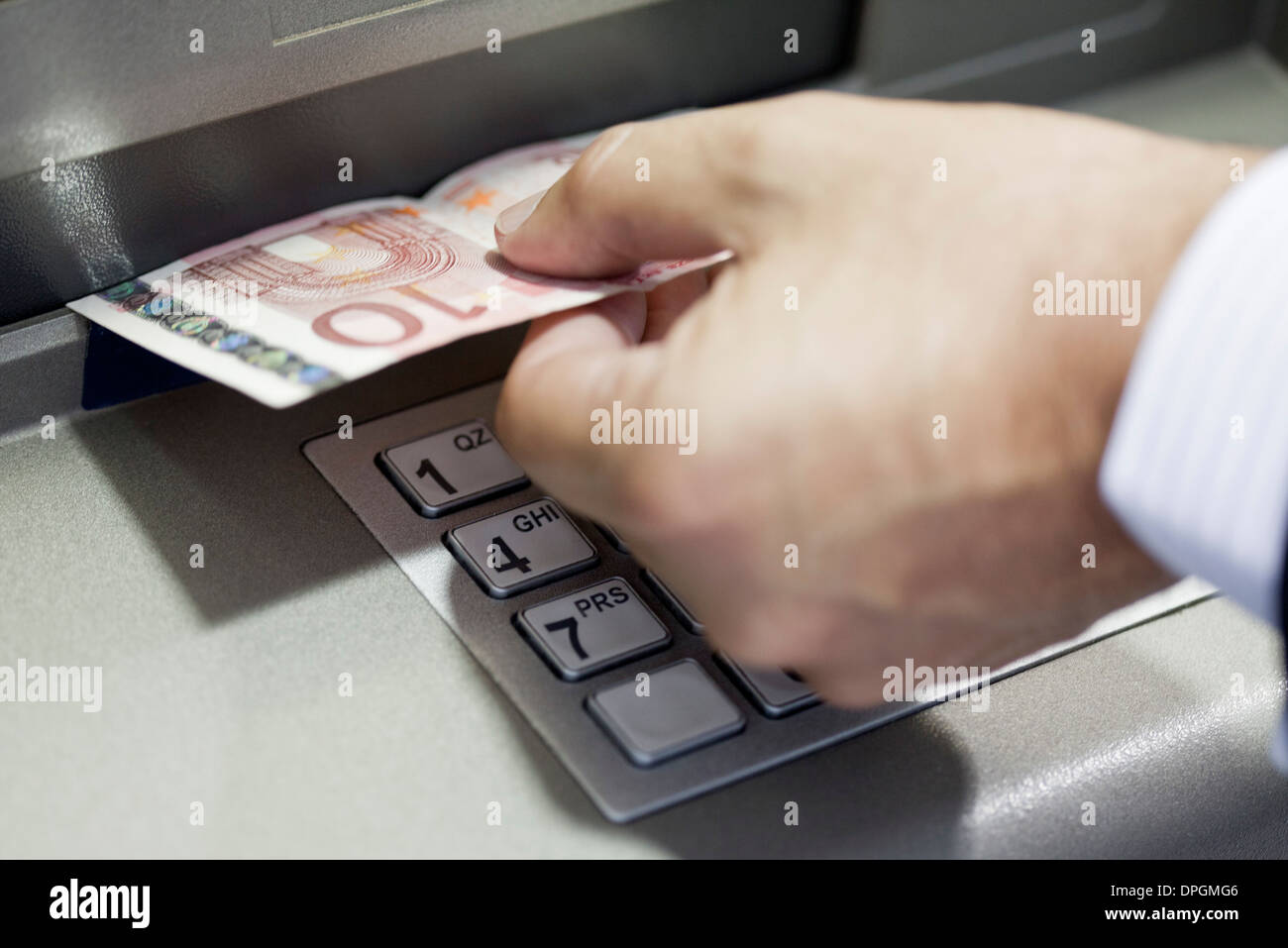 Hand withdrawing banknotes from atm hi-res stock photography and images ...