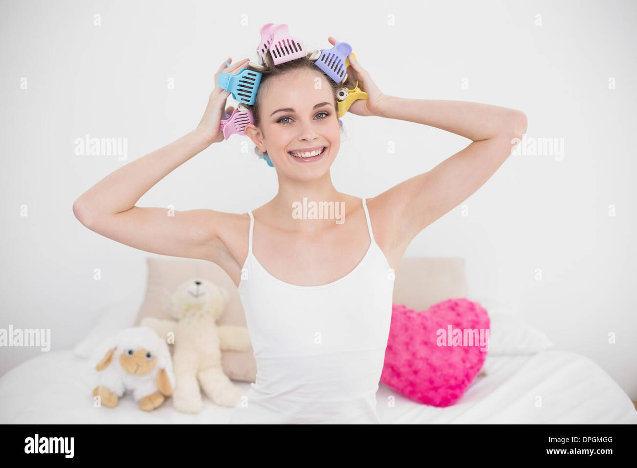 Woman looking camera fixing hair hi-res stock photography and images ...