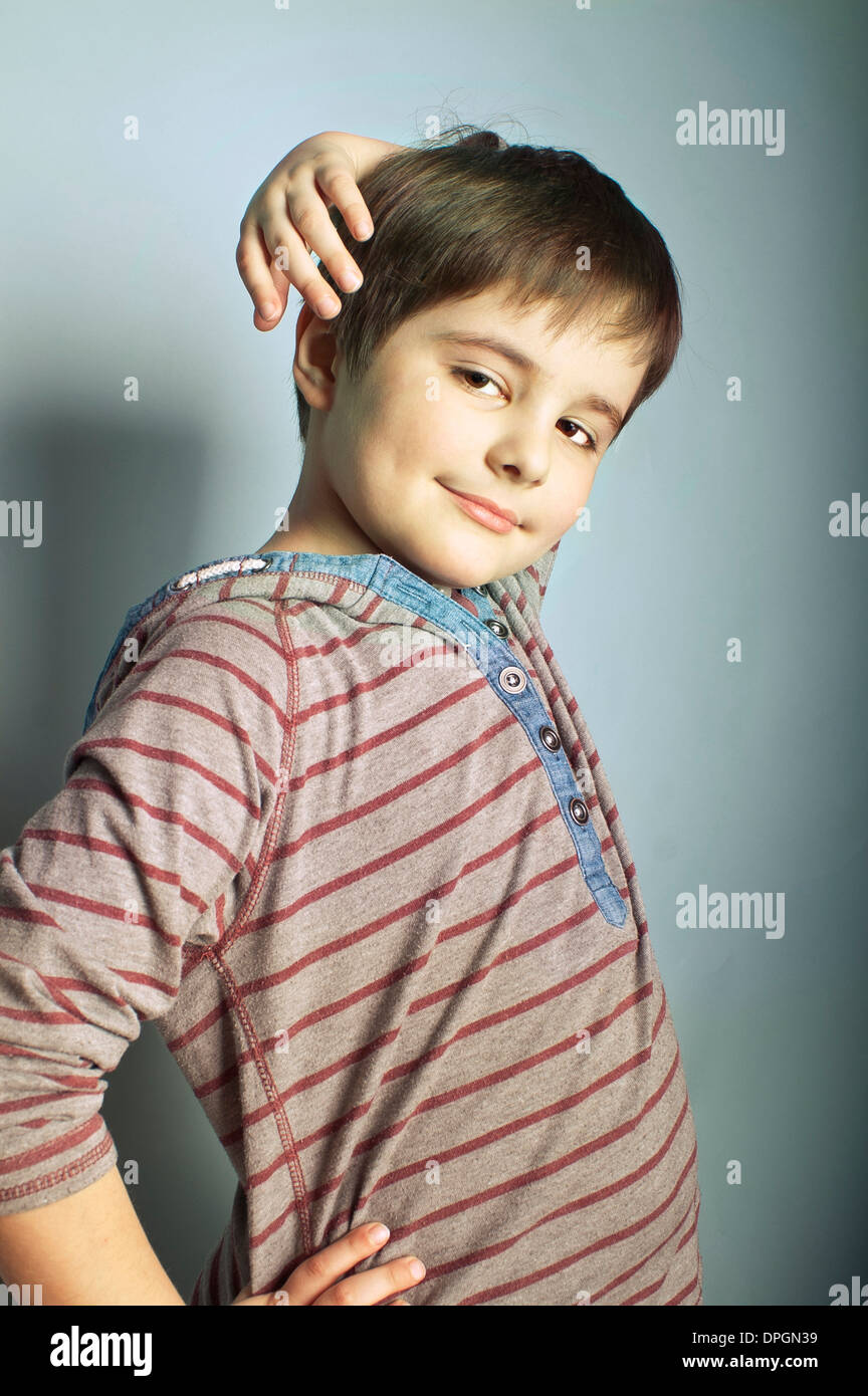 young smiling boy standing and posing in studio Stock Photo - Alamy