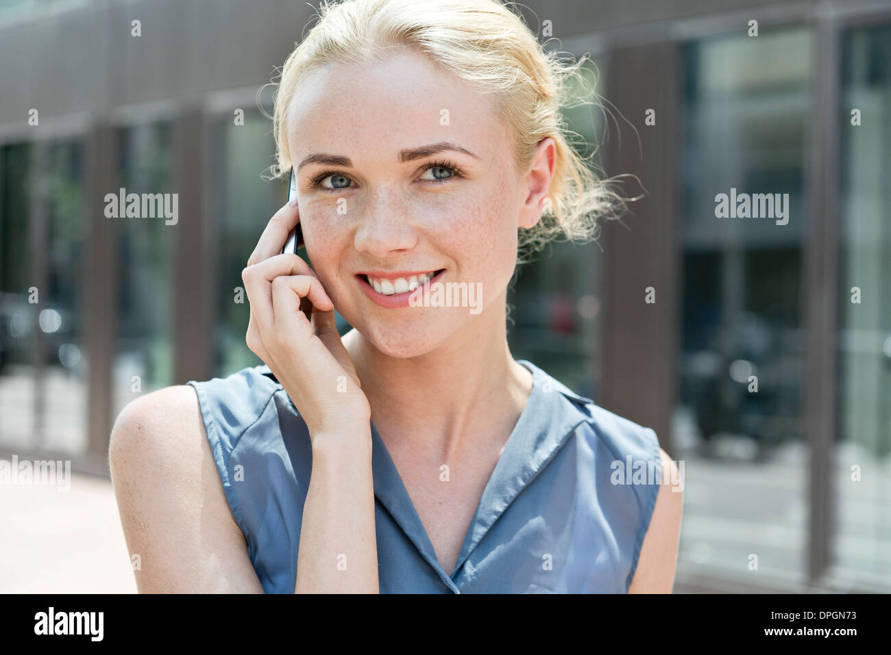 Young woman making phone call using smartphone Stock Photo - Alamy