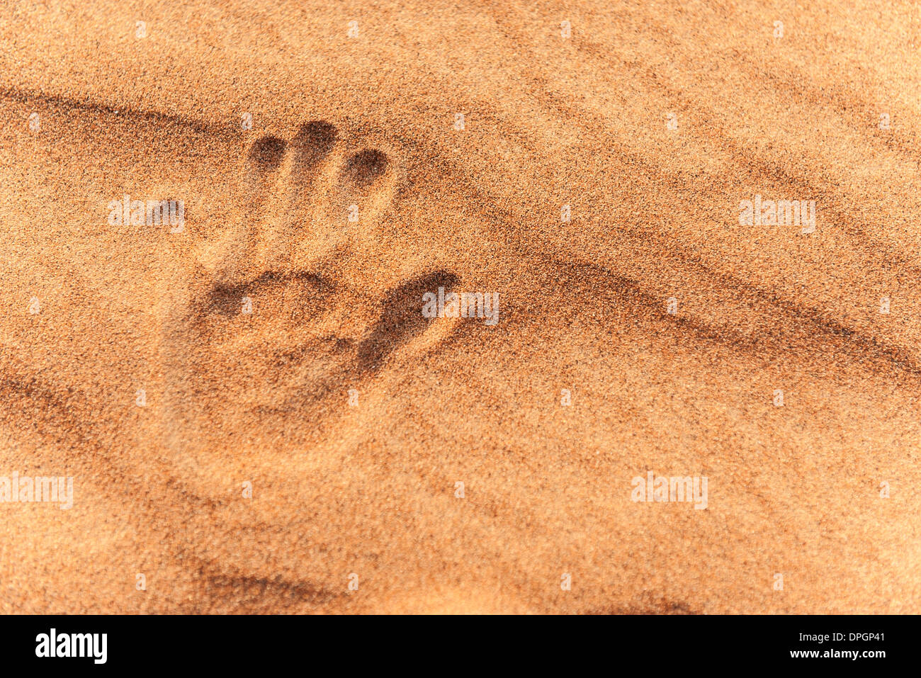 Handprint in sand Stock Photo - Alamy
