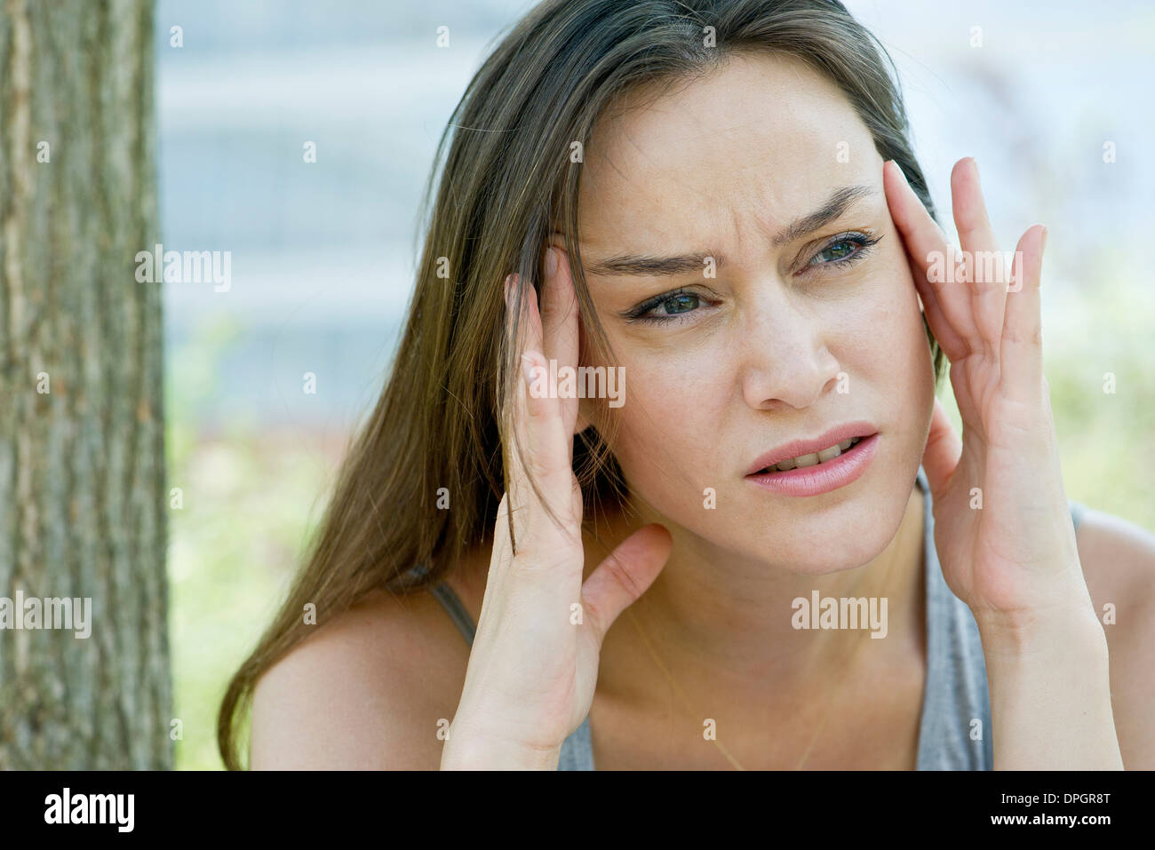 Woman rubbing temples Stock Photo - Alamy