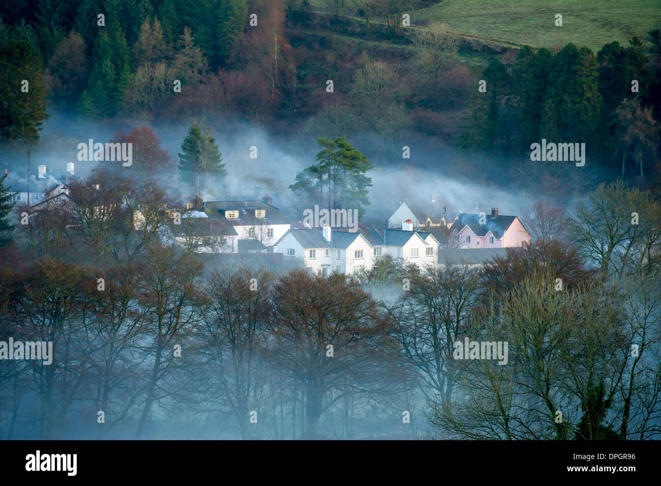 Early morning mist surrounds the small village of Withypool on Exmoor ...
