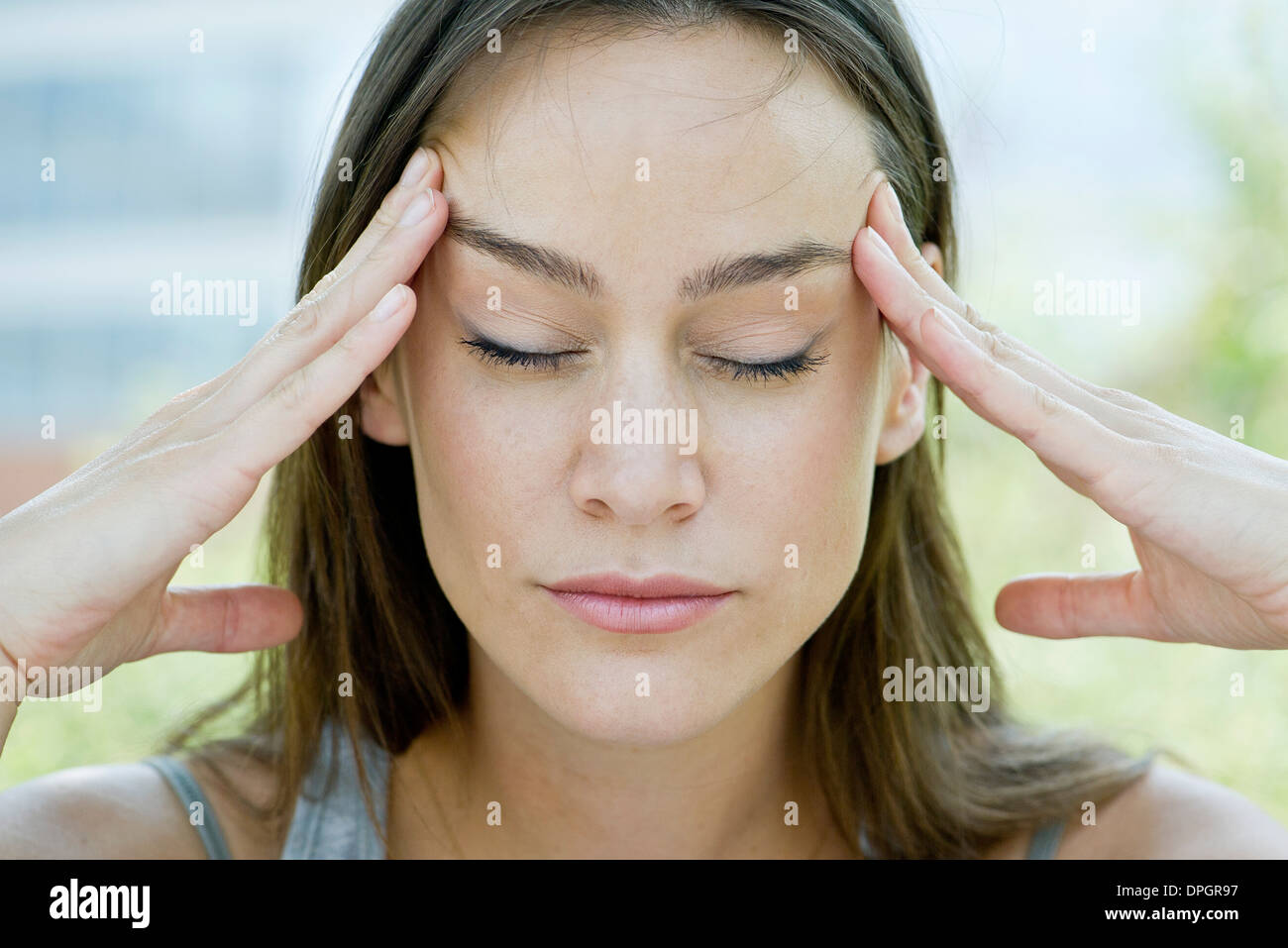 Woman with head in hands Stock Photo - Alamy