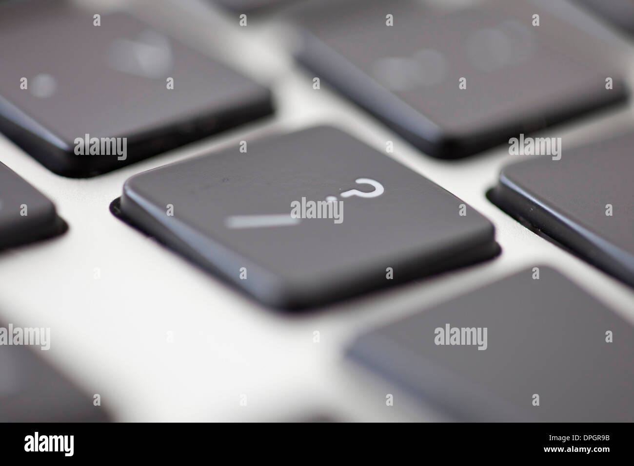 Laptop computer, focus on question mark key Stock Photo - Alamy
