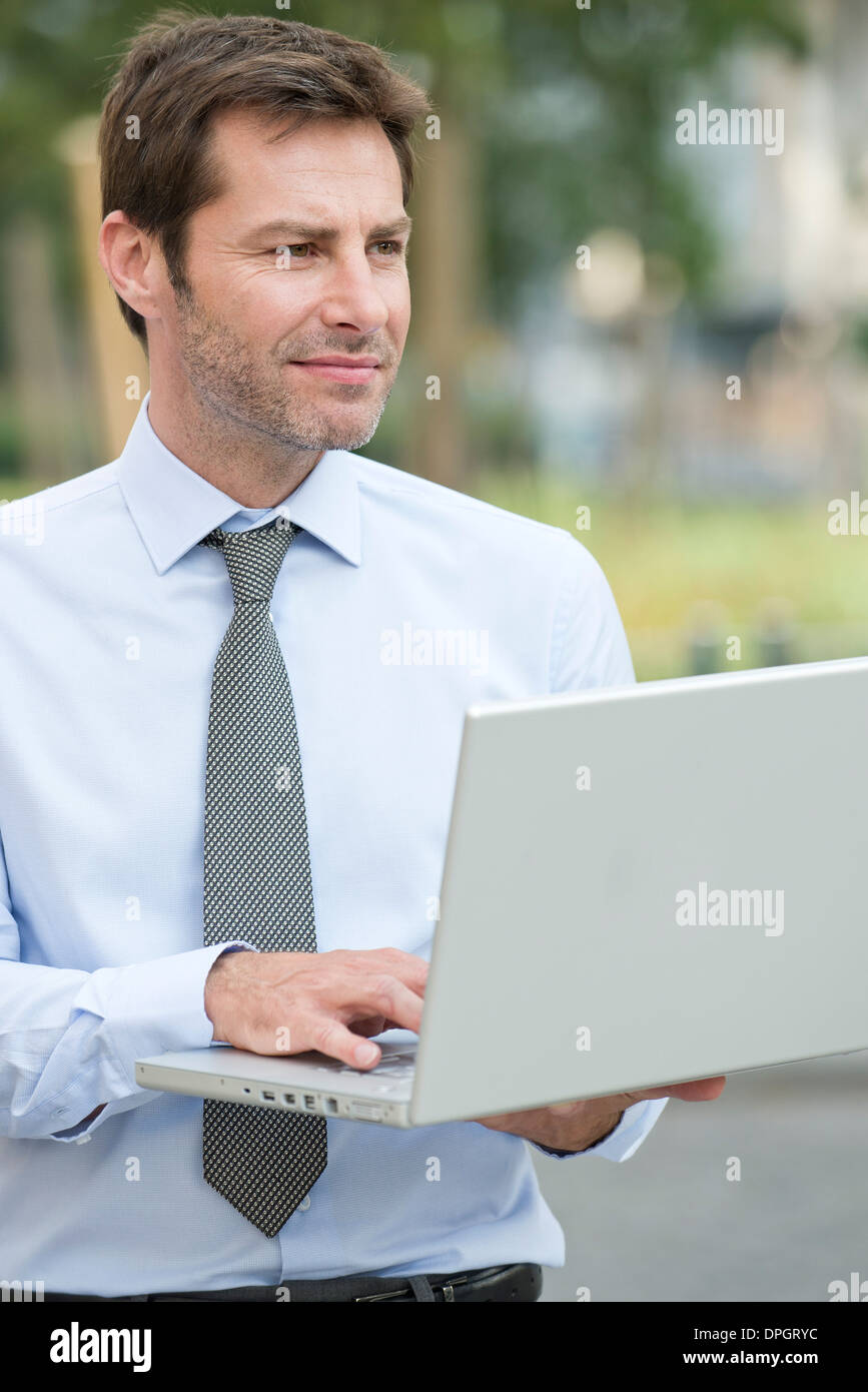 Businessman on laptops outside hi-res stock photography and images - Alamy