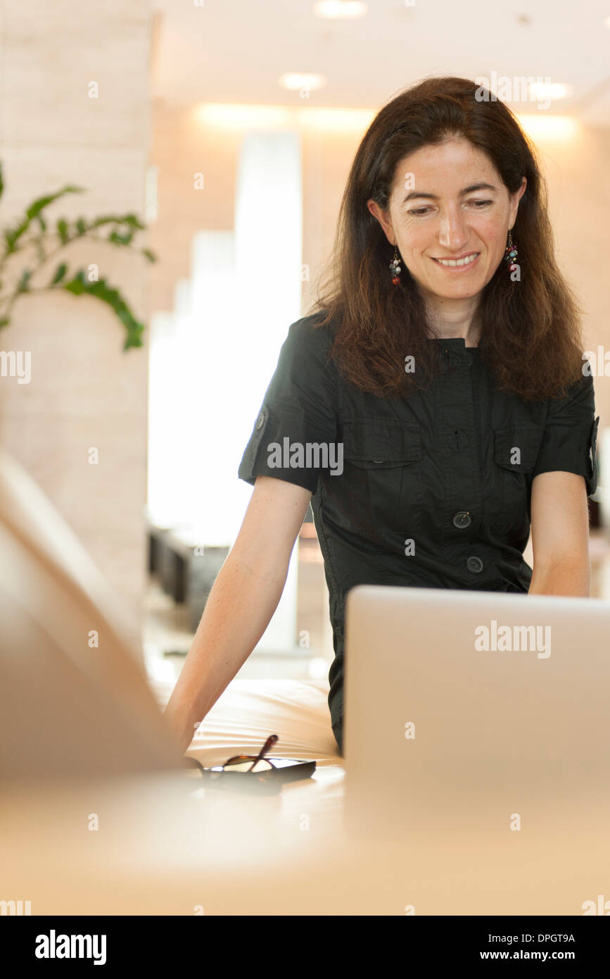 Woman using laptop computer, smiling Stock Photo - Alamy
