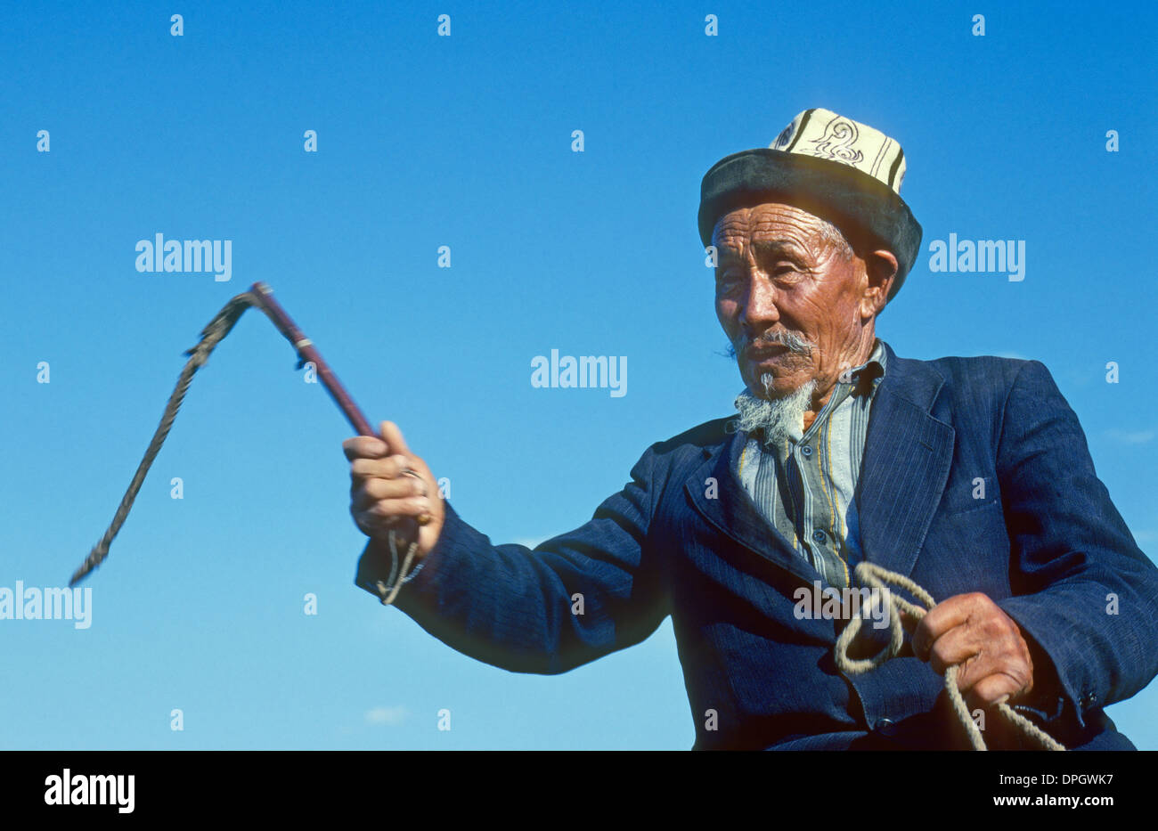 Portrait horseman with whip playing Kokboru Kyrgyzstan Stock Photo - Alamy