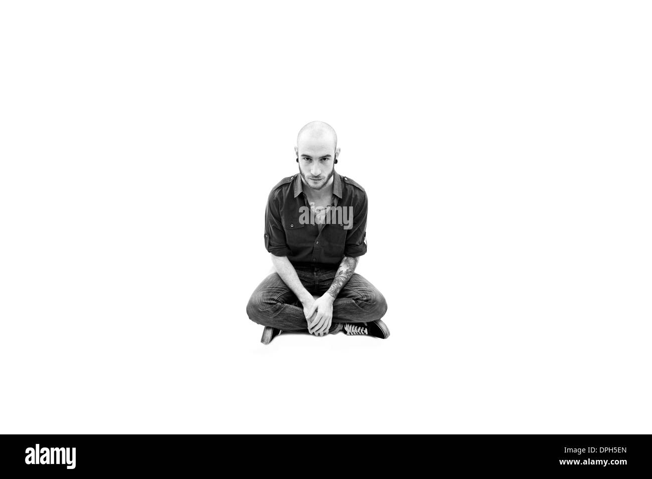 Young man sitting out Stock Photo - Alamy