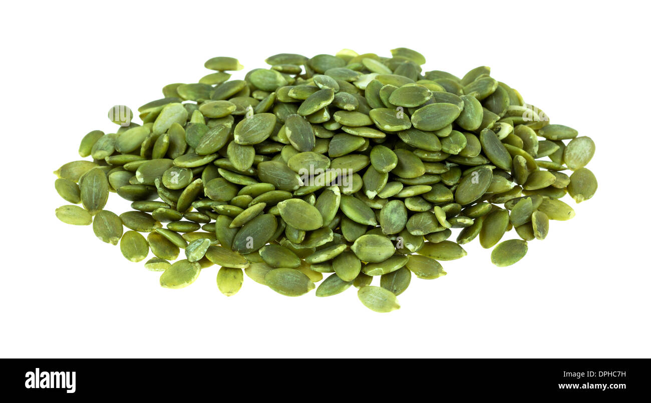 A large serving of green pepitas on a white background Stock Photo - Alamy