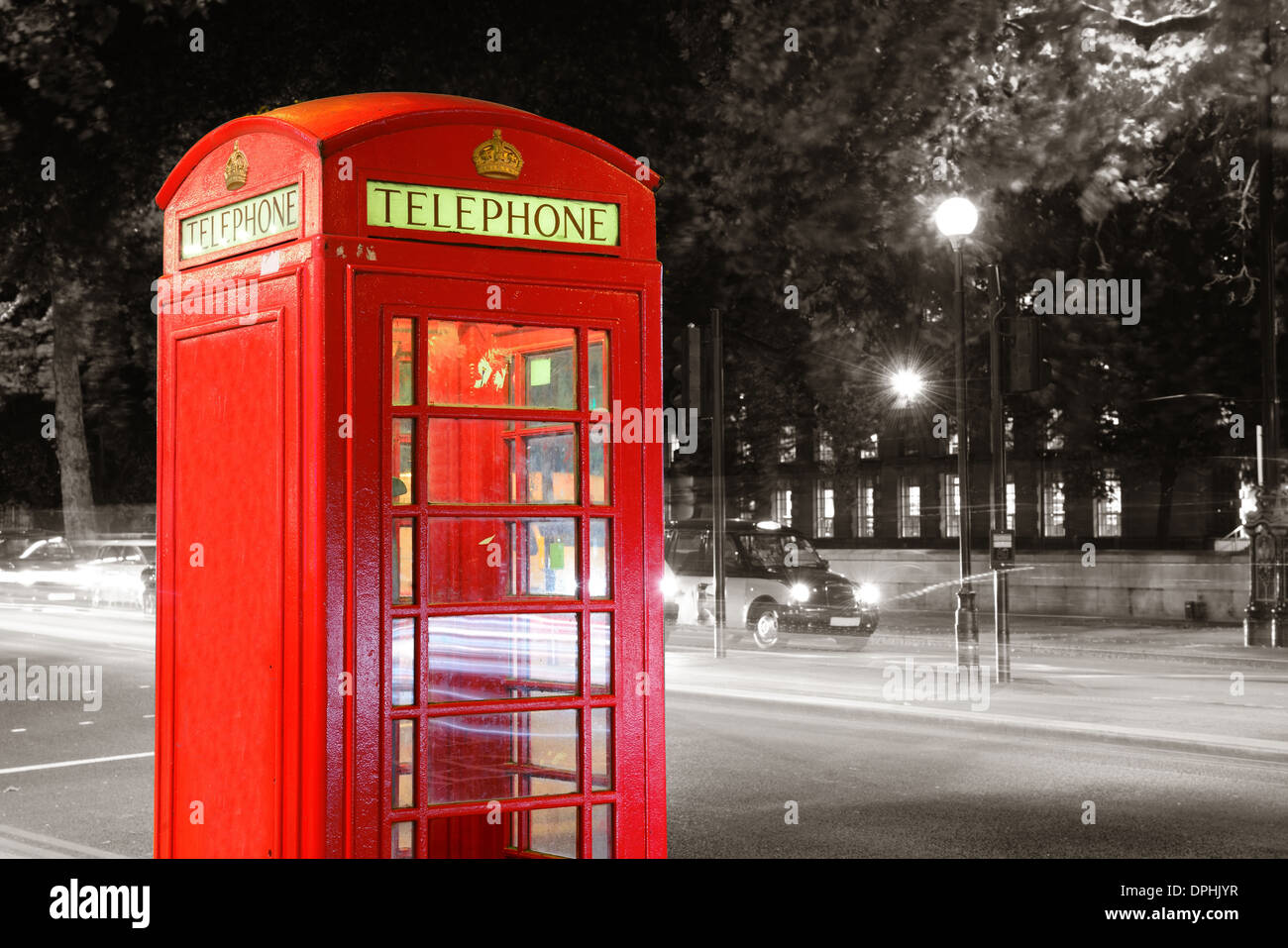 Red Telephone Booth in street at night in London Stock Photo - Alamy