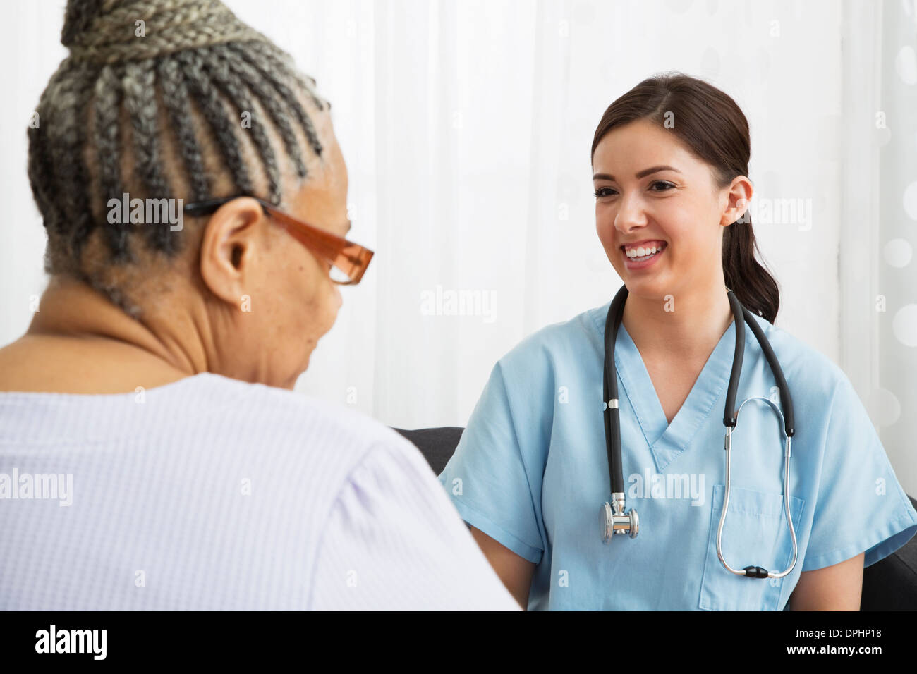 Senior woman and nurse during check-up Stock Photo - Alamy