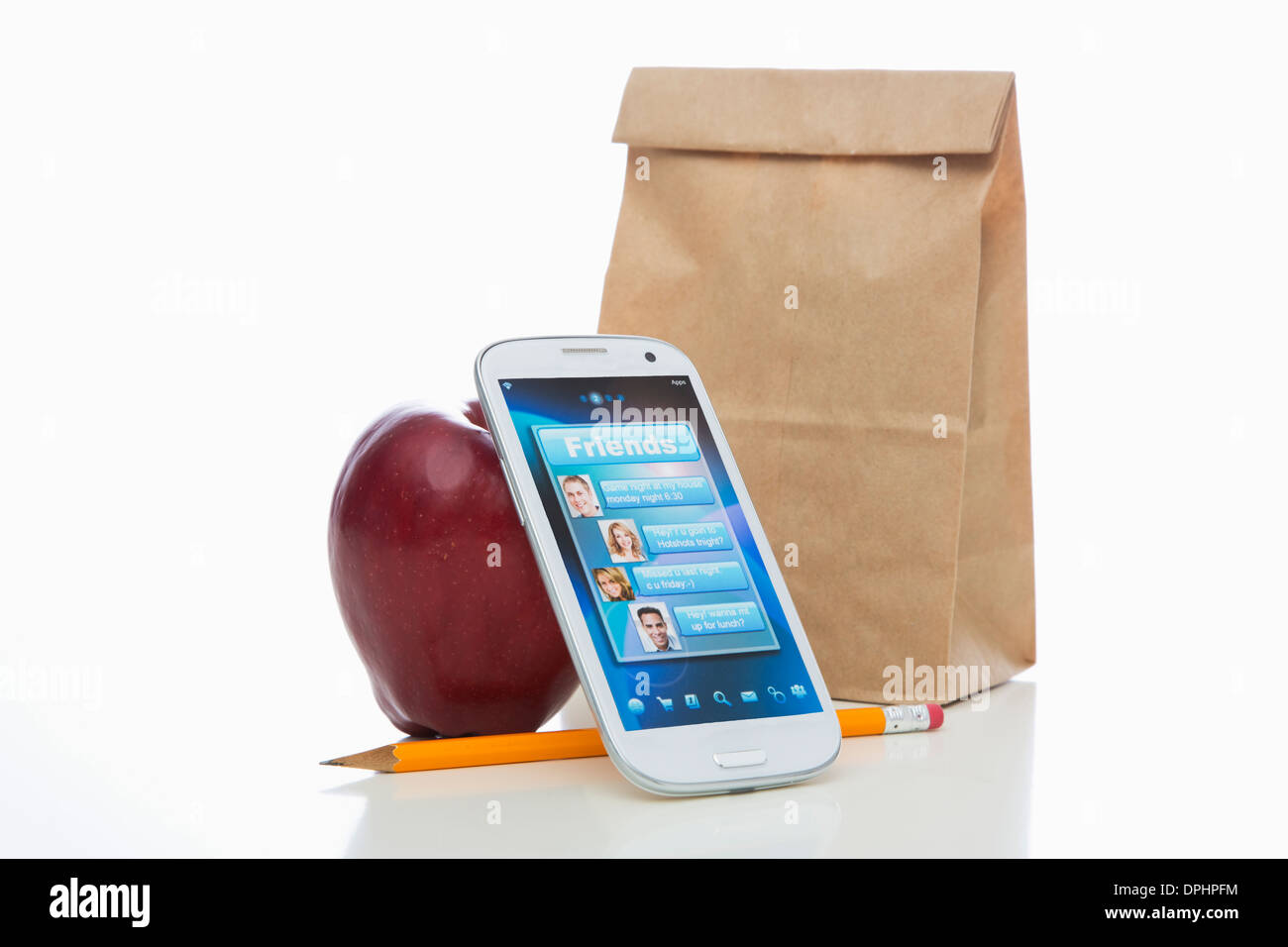 Paper bag, apple, cell phone and pencil on white background Stock Photo ...