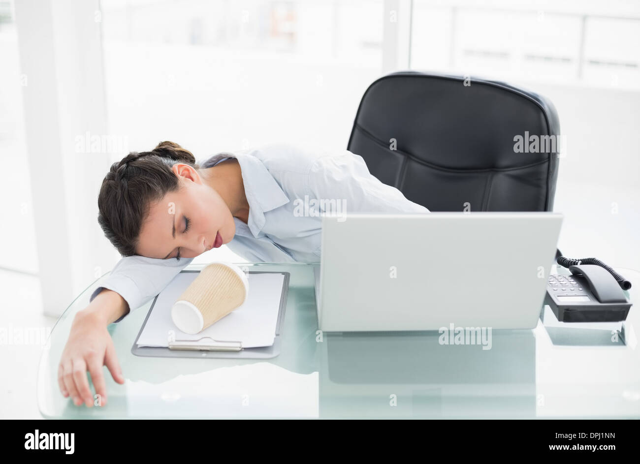 Sleepy stylish brunette businesswoman lying on her desk Stock Photo - Alamy
