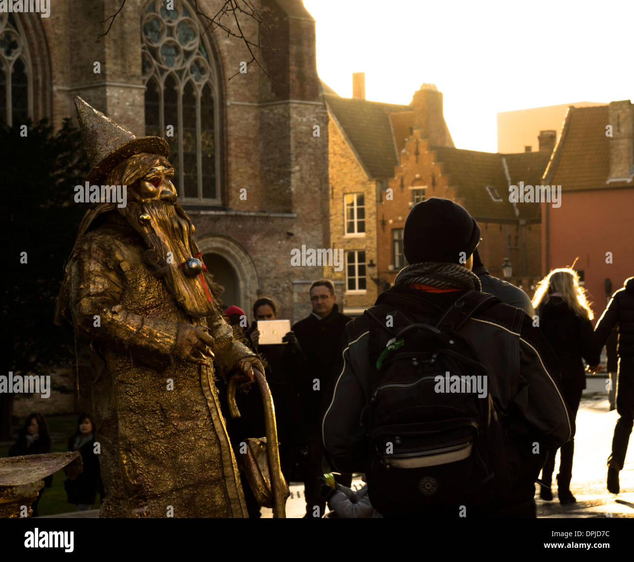human gold wizard living statue tourist interacting with crowed ...