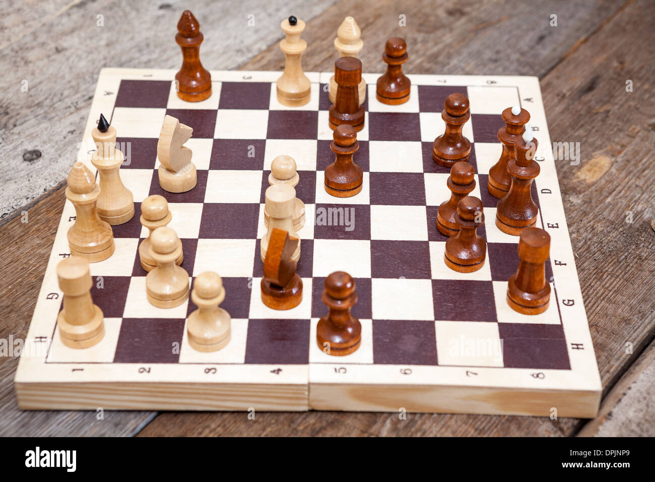 Chess wooden figures in game on timber floor Stock Photo - Alamy