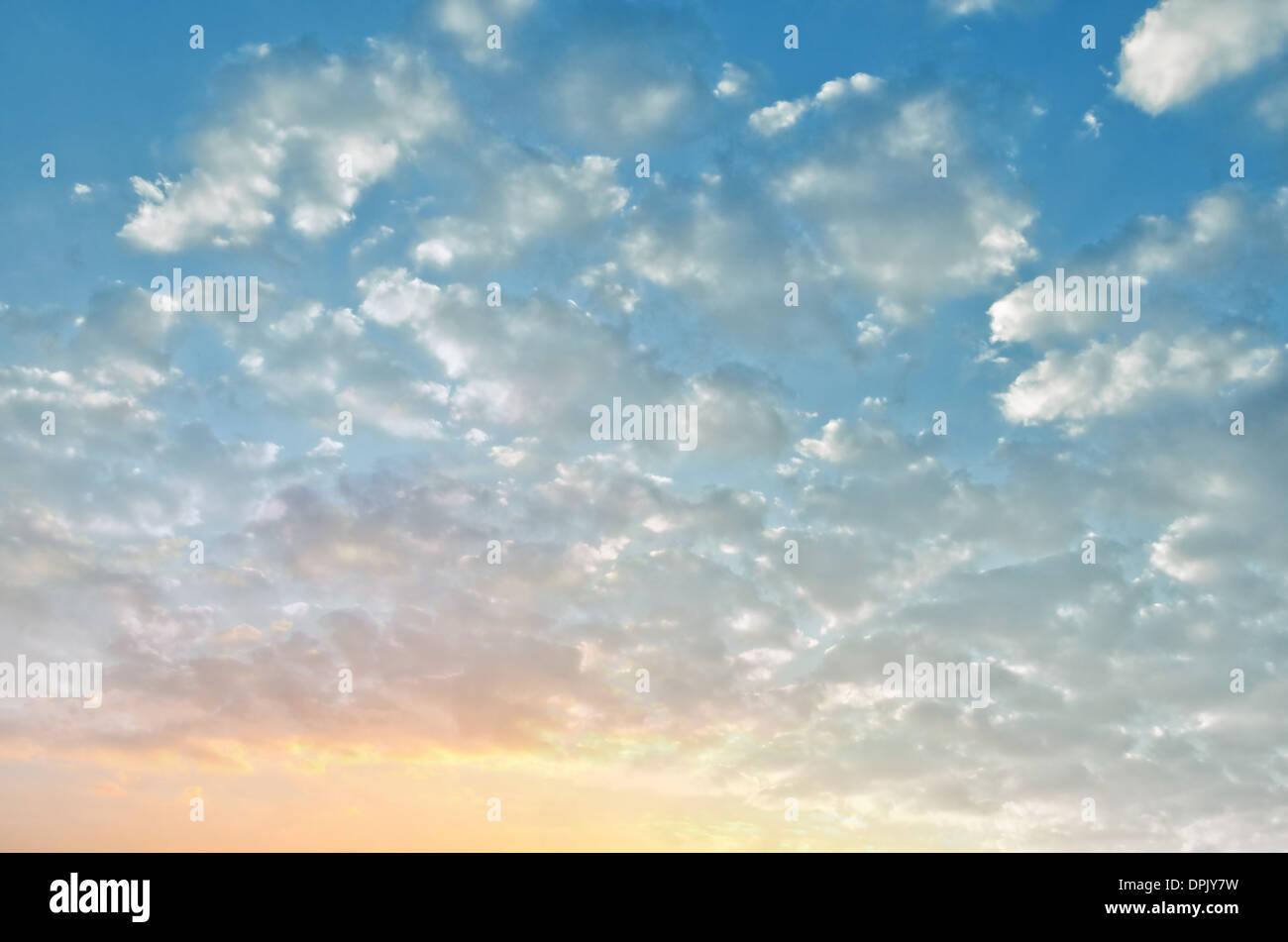 Yellow blue sunset sky with sunlight Stock Photo - Alamy